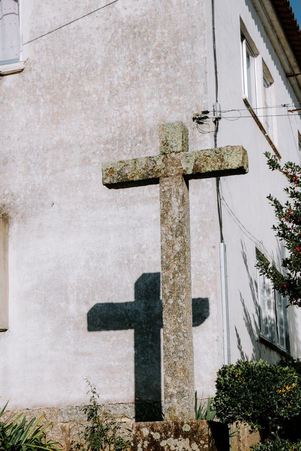 Vertical Shot of a Stone Cross in Front of a Building Stock Photo ...