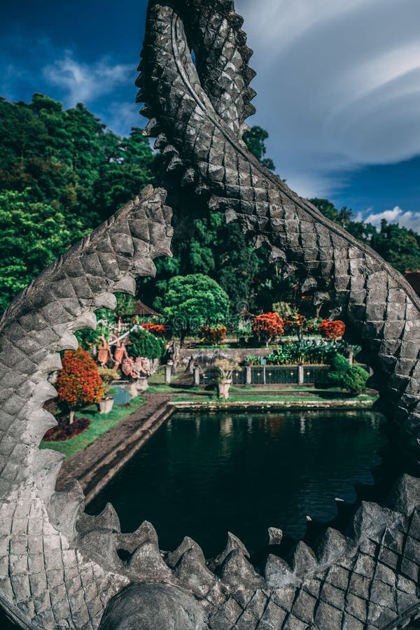 Vertical Shot through a Stone Feature of a Lake Surrounded by Plants ...