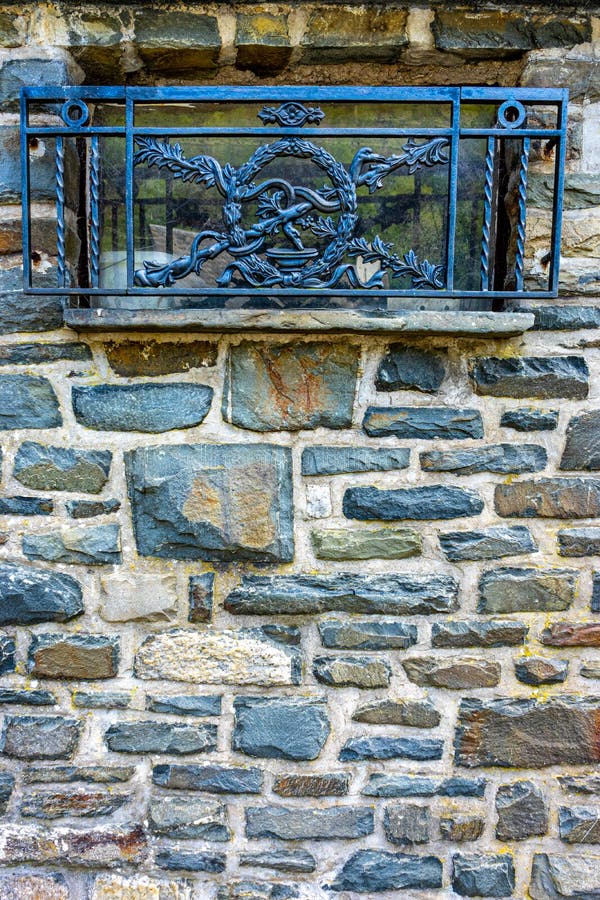 Vertical Shot of Stone Wall Texture with Blue Wrought Iron Grates Stock ...