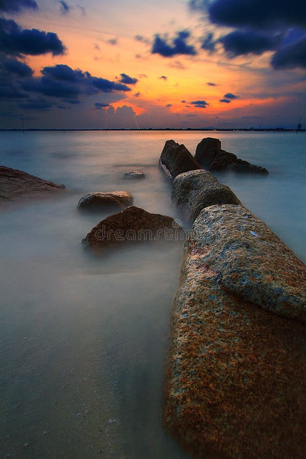 Vertical Shot of the Stones Covered with Mist and a Picturesque Sunset ...