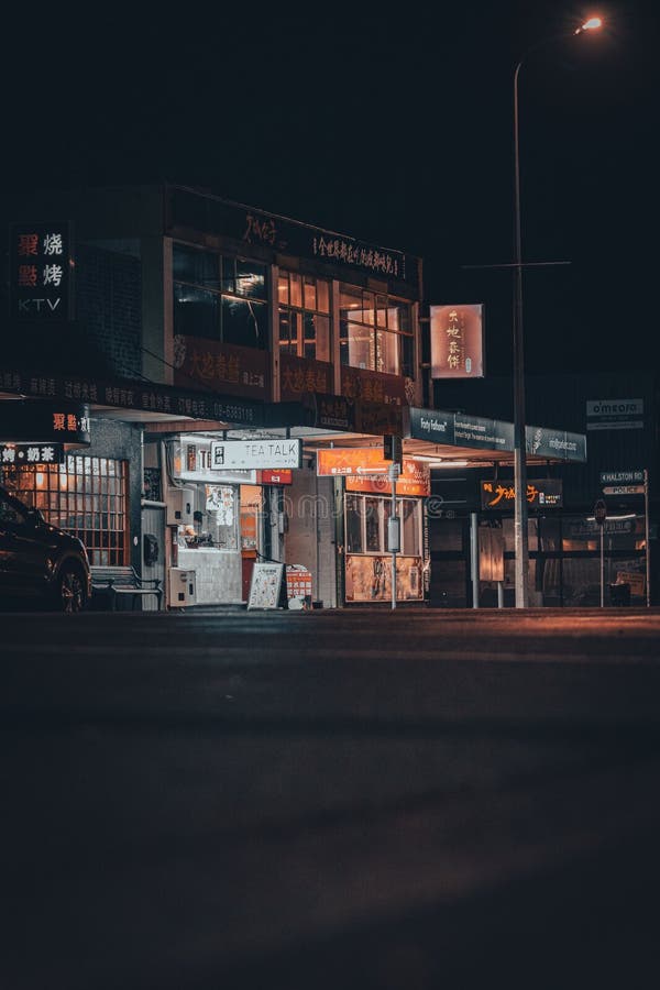 Vertical Shot of the Street View of Stores at Night Editorial Stock ...