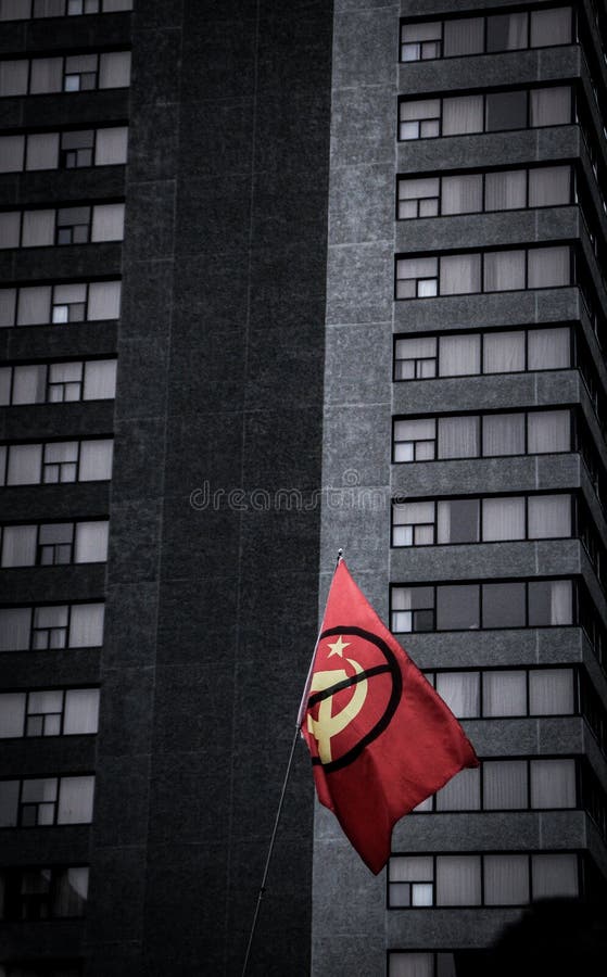 Vertical Shot of a Strike-out Communist Flag Against a Building in ...