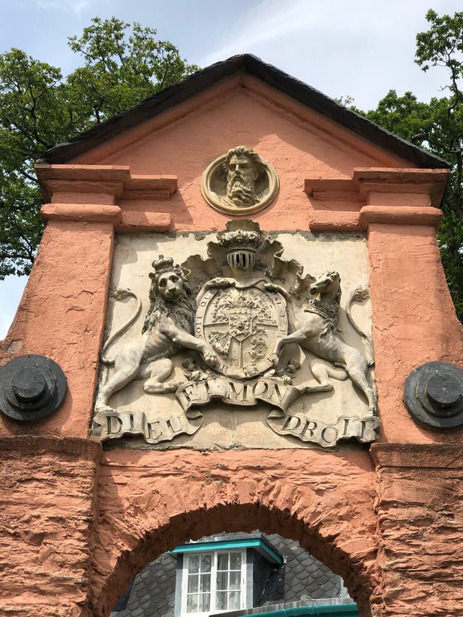 Vertical Shot of a Structure with a Statue of an Emblem in Portmeirion ...