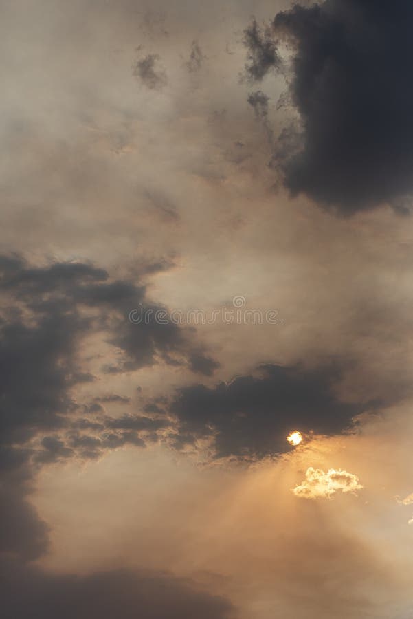 Vertical Shot of the Sun Covered with Storm Clouds during Sunset Stock ...