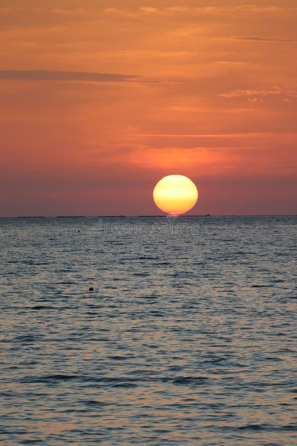 Vertical Shot of the Sun Going Down Over the Ocean Stock Photo - Image of evening, dusk: 263431896