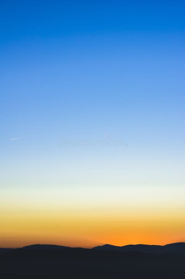 Vertical Shot of the Sunset Over a Mountainous Scenery Stock Image ...