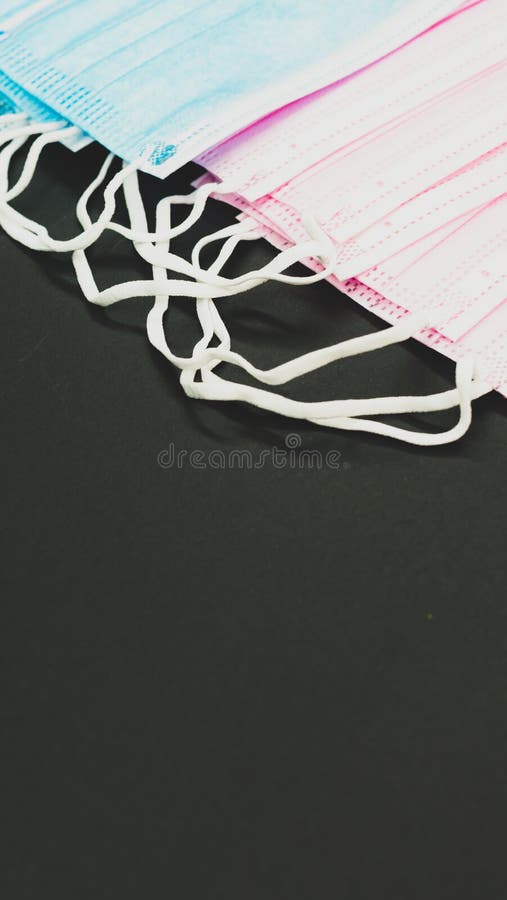 Vertical Shot of Surgical Masks on a Black Surface Stock Image - Image ...