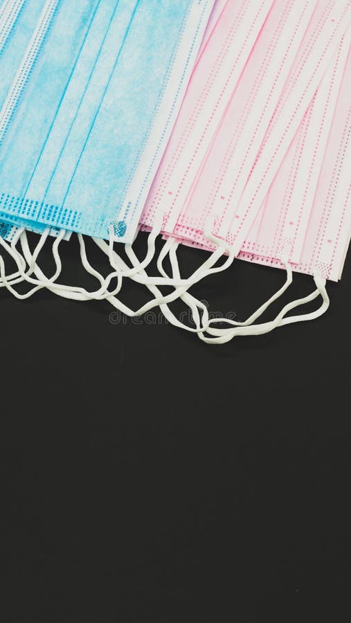 Vertical Shot of Surgical Masks on a Black Surface Stock Photo - Image ...