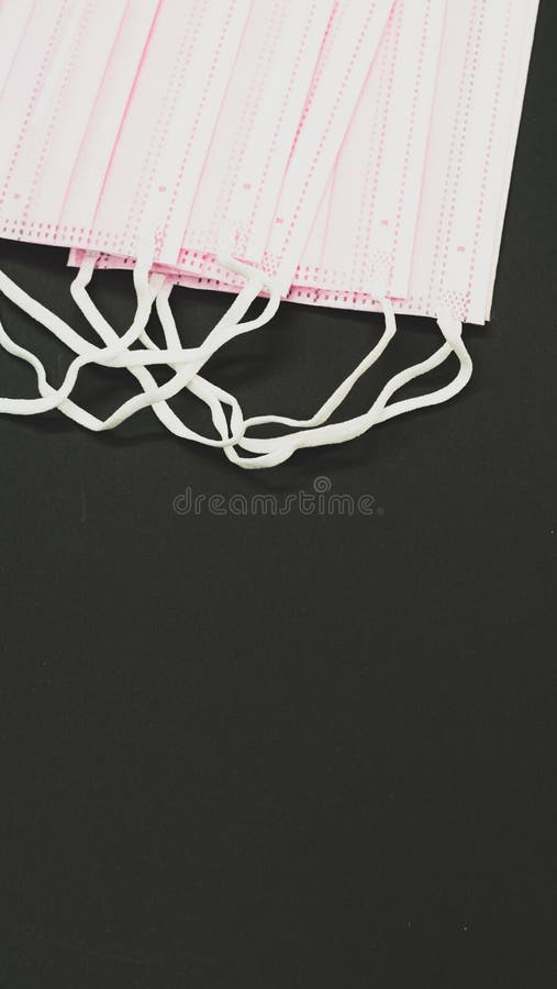 Vertical Shot of Surgical Masks on a Black Surface Stock Image - Image ...