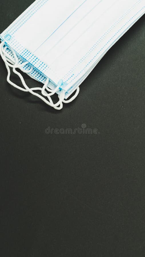 Vertical Shot of Surgical Masks on a Black Surface Stock Image - Image ...