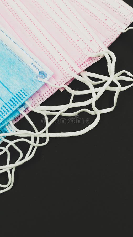 Vertical Shot of Surgical Masks on a Black Surface Stock Photo - Image ...