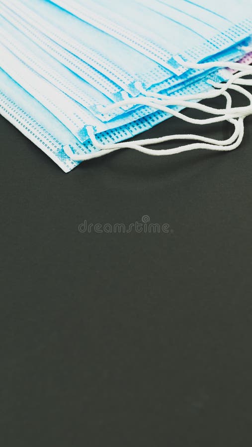 Vertical Shot of Surgical Masks on a Black Surface Stock Image - Image ...