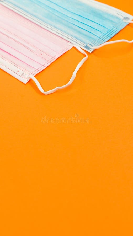 Vertical Shot of Surgical Masks on an Orange Surface Stock Image ...