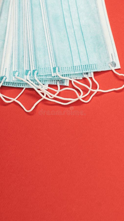 Vertical Shot of Surgical Masks on a Red Surface Stock Image - Image of ...