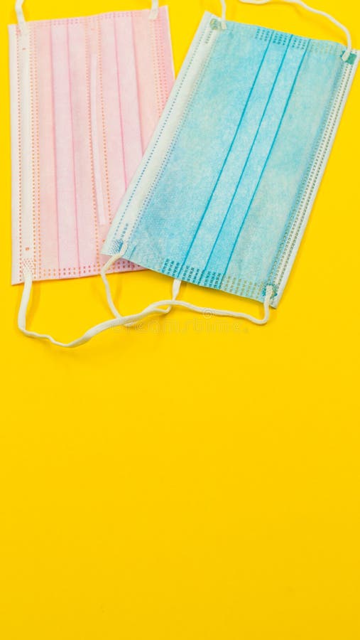 Vertical Shot of Surgical Masks on a Yellow Surface Stock Photo - Image ...