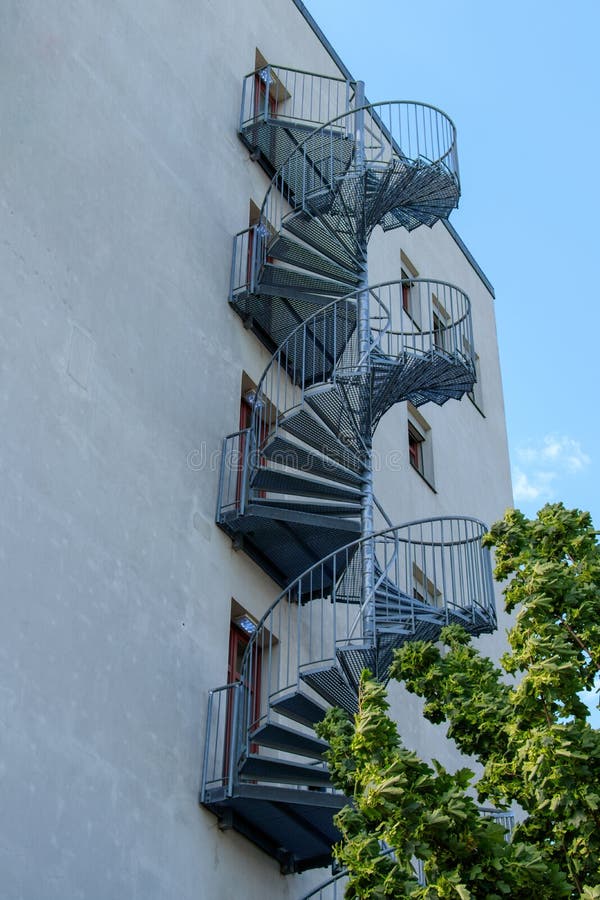 Vertical Shot of a Tall Building with a Spiral Metal Staircase on the ...