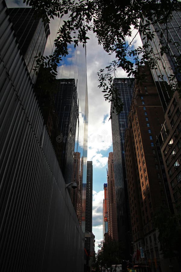 Vertical Shot of Tall City Building with Cloudy Sky in the Background ...