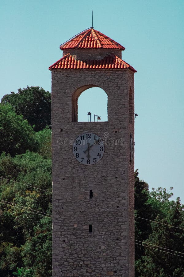 A Tall Old Stone Bell Tower Made of Red Brick Against a Blue Sky with ...