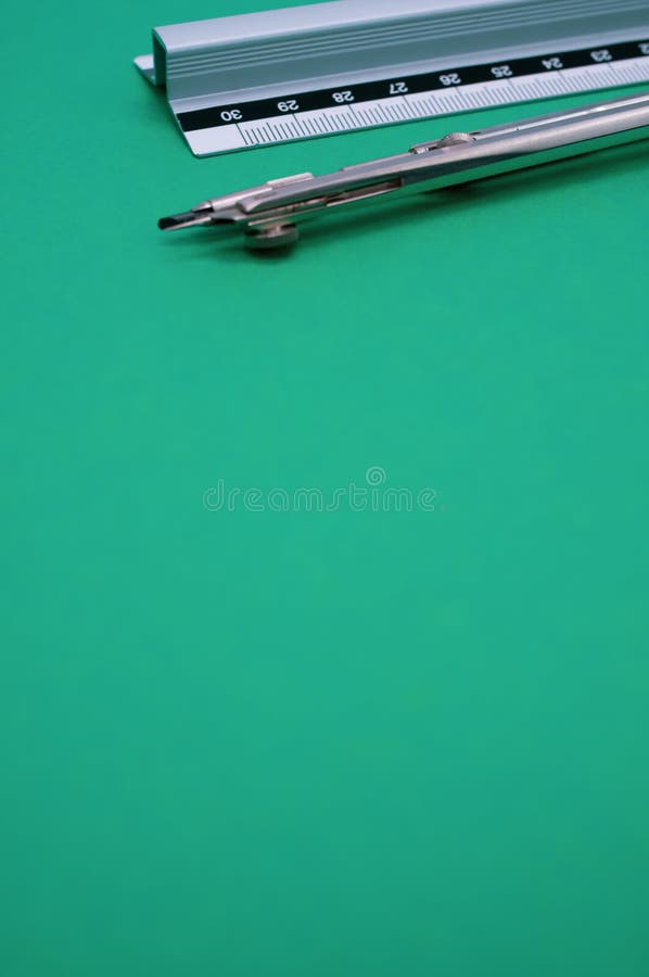 Vertical Shot of Technical Drawing Tools on a Green Background with a ...