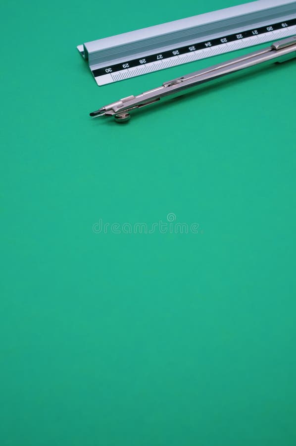 Vertical Shot of Technical Drawing Tools on a Green Background with a ...