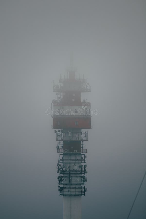 Vertical Shot of a Telecommunication Tower Covered in Fog Stock Photo ...
