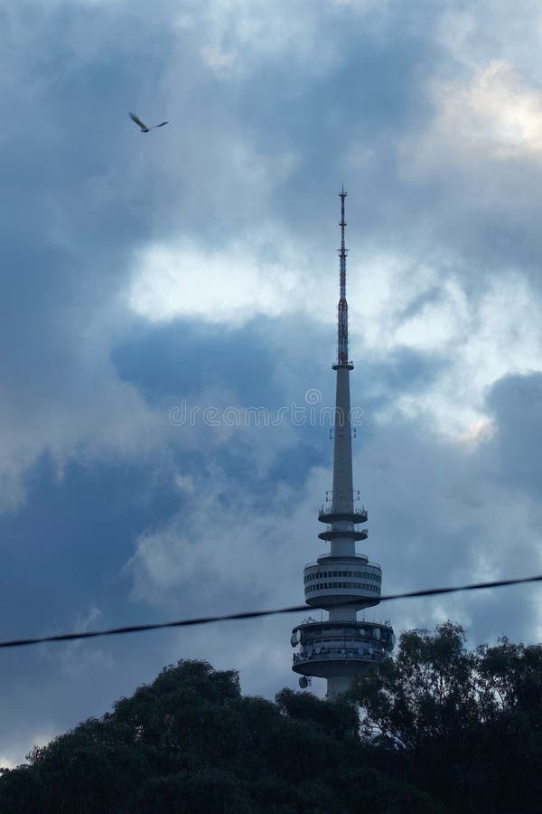 Vertical Shot of the Telstra Tower with a Cloudy Sky Background Stock ...