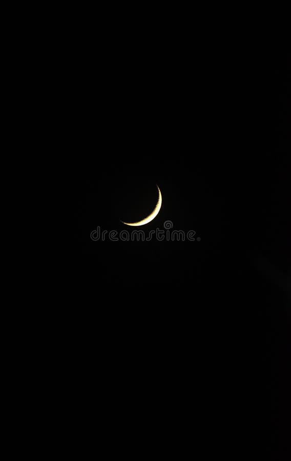 Vertical Shot of a Thin Crescent Moon in a Dark Night Sky Stock Photo ...