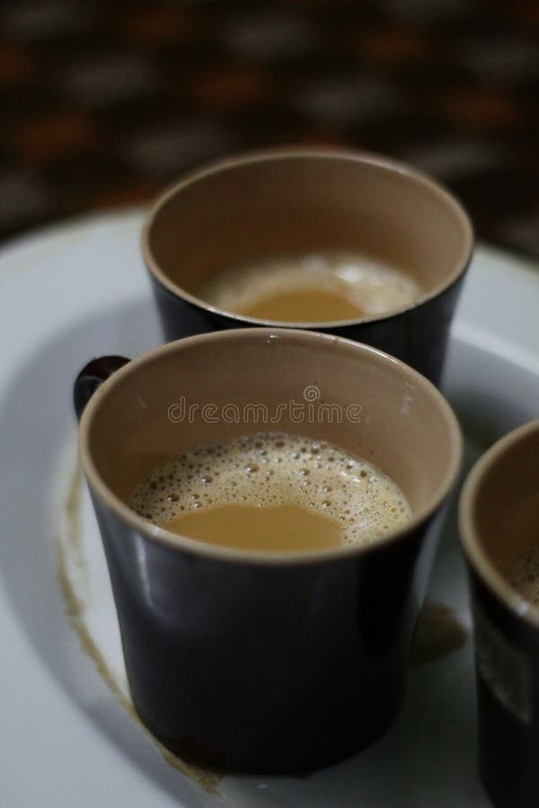 Vertical Shot of Three Coffee Mugs in a Tray. Stock Image - Image of ...