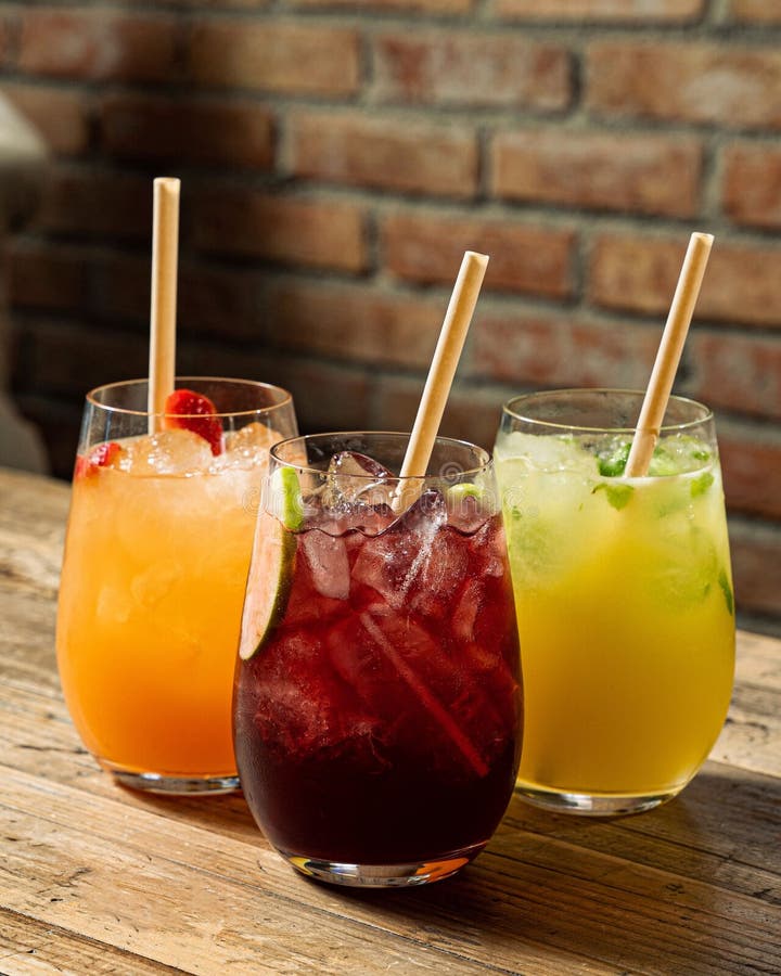 Vertical Shot of Three Colorful Mocktail Drinks with Straws Stock Photo ...