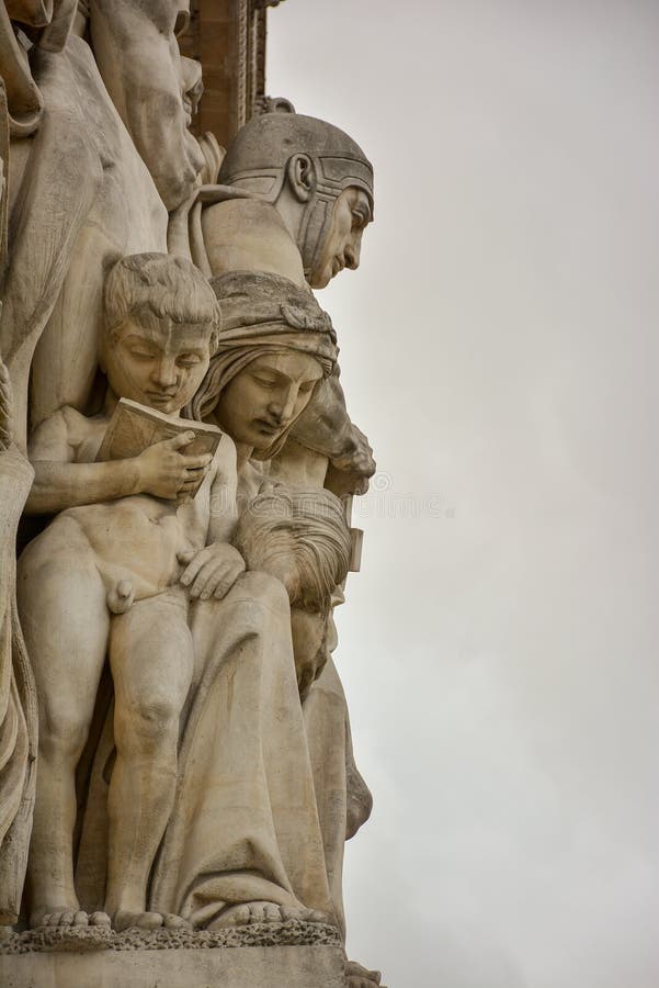 Vertical Shot of Three Statues Under a Clouded Sky Stock Image - Image ...