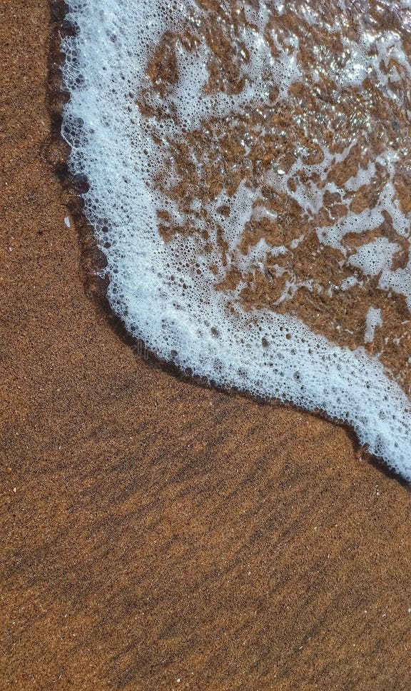 Vertical Shot of a Tidal Foam on a Beach Sand Stock Image - Image of ...