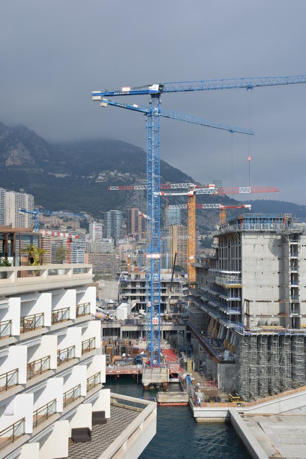 Vertical Shot of Tower Cranes beside a Building Undergoing Construction ...