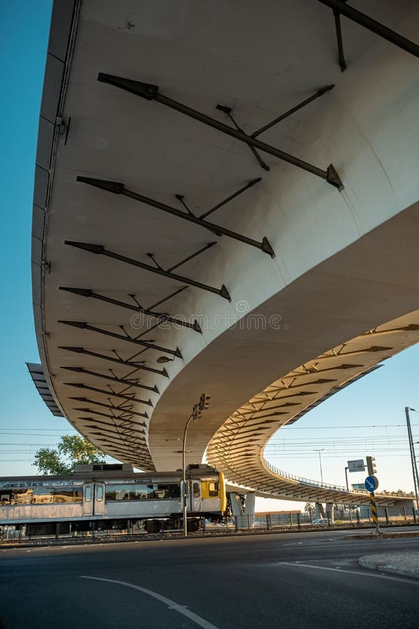 Vertical Shot of a Train Under the Bridge in Alges, Lisbon Stock Photo ...