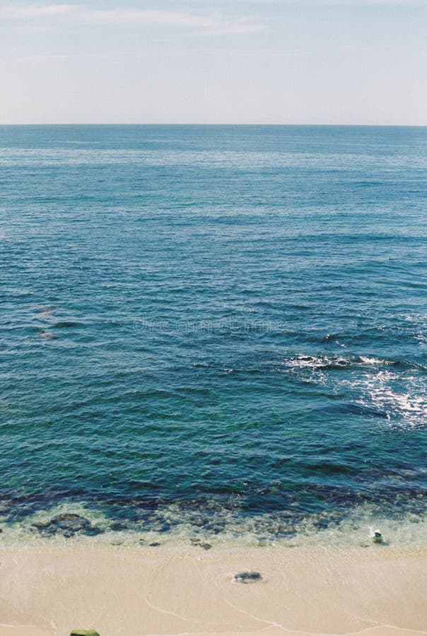 Vertical Shot of Tranquil Sea Waves Hitting a Sandy Shore Stock Image ...