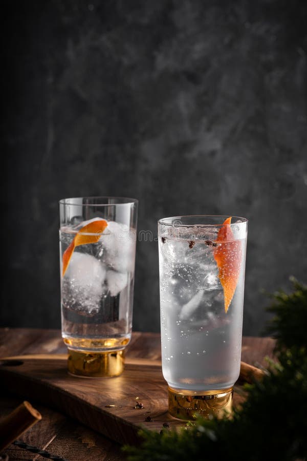 Vertical Shot of a Transparent Cocktail in a Glass Placed on a Wooden ...