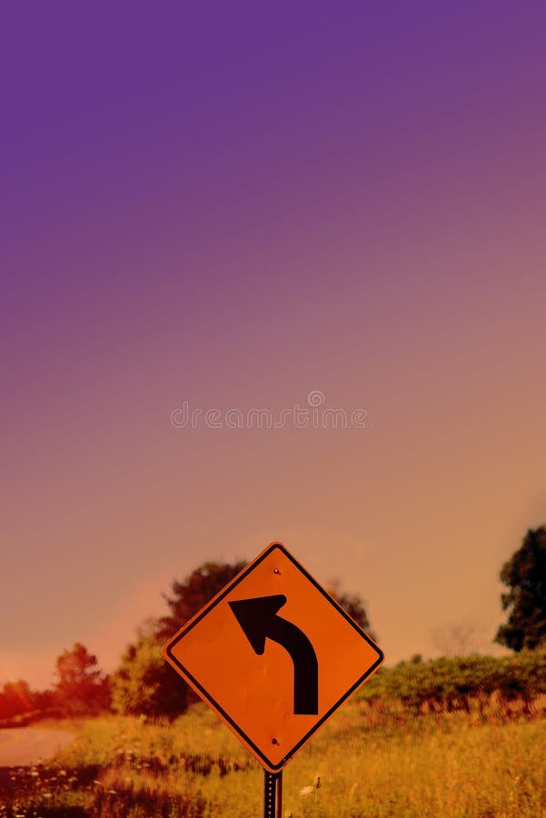 Vertical Shot of a Turn Sign with a Blurred Background Stock Image ...