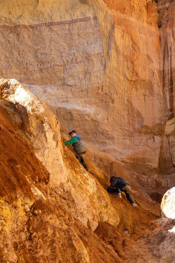 Vertical Shot of Two Boys Climbing the Rocky Cliffs Stock Photo - Image ...