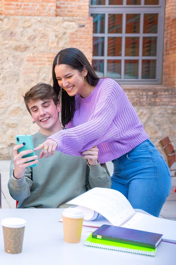 Vertical Shot Two Friends Browsing an Internet Application with a ...