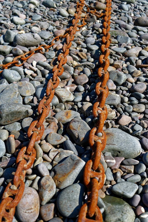 Vertical Shot of Two Old Rusty Chains on the Pebbles on the Coast Stock ...