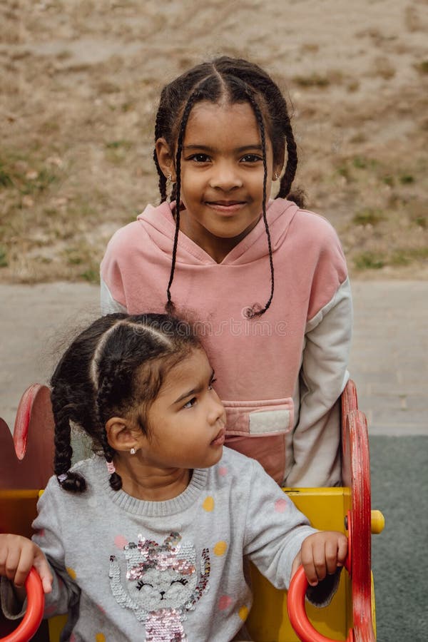 Vertical Shot of Two Sisters in a Playground Stock Image - Image of ...
