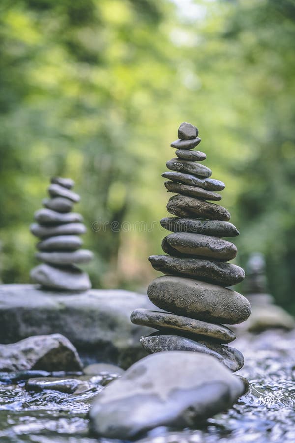 Vertical Shot of Two Stone Pyramids Balanced on a River Water Stock ...