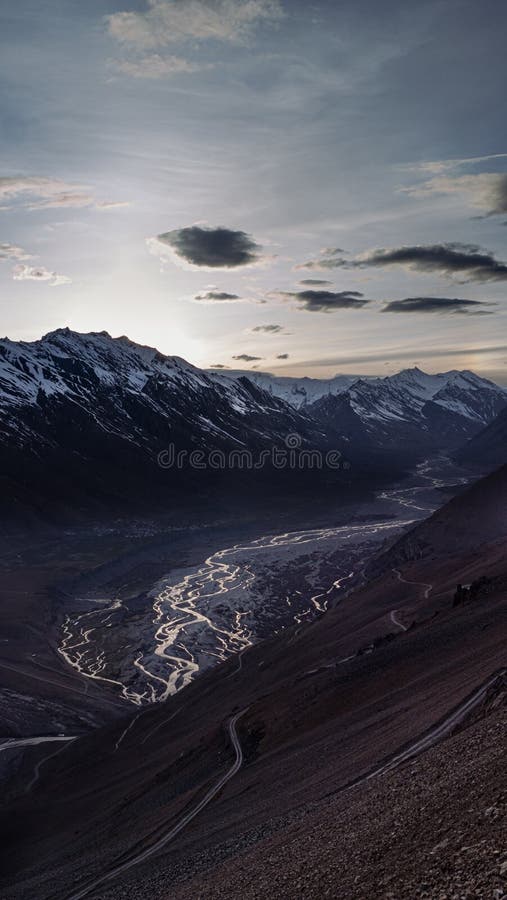 Vertical Shot of Veins of Earth with Sunlight Reflecting in a River in ...