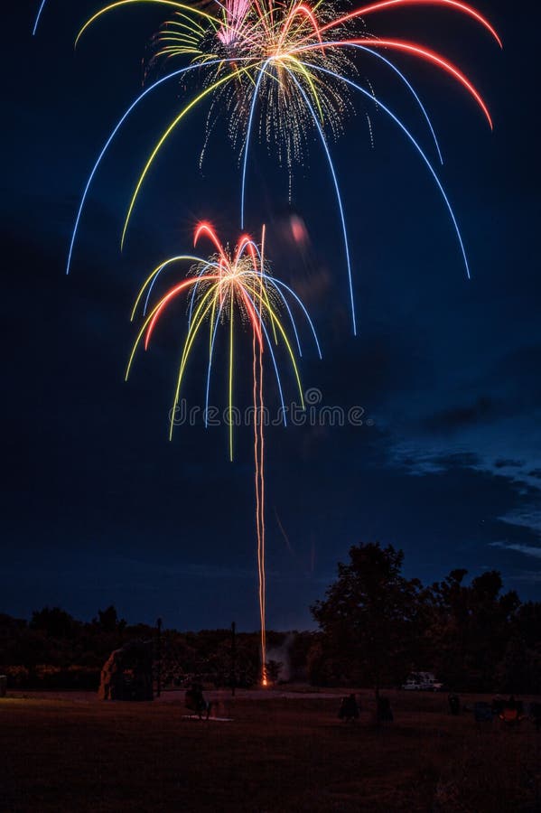 Vertical Shot of Vibrant, Colorful Fireworks Exploding in the Blue Sky ...