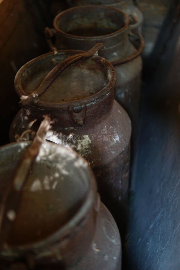 Vertical Shot of Vintage Milk Jugs Stock Image - Image of rusty, brown ...