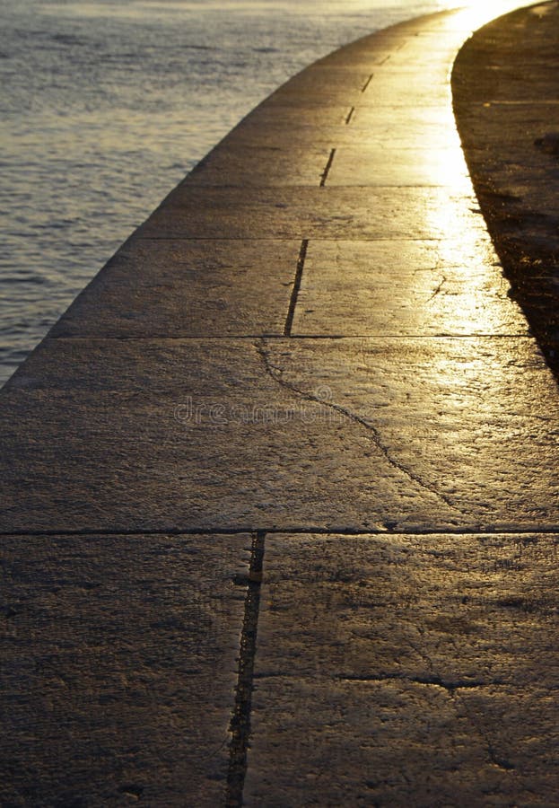 Vertical Shot of a Walkway Made of Stone Next To the Ocean Stock Image ...