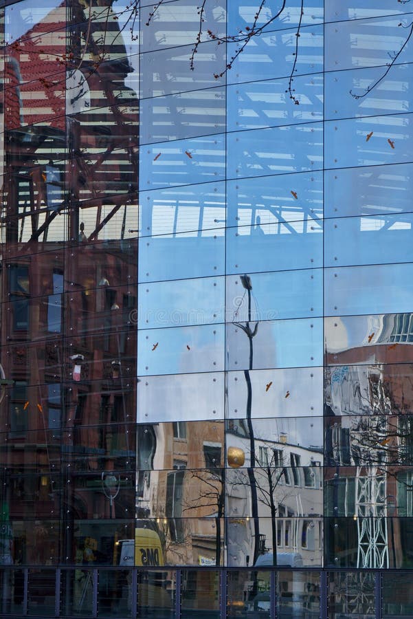 Vertical Shot of a Wall Covered with Windows and Reflection on it ...