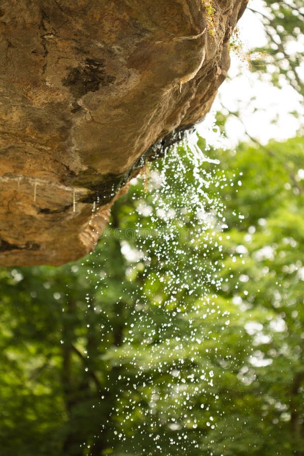 Vertical Shot of Water Falling from a Rock Stock Photo - Image of ...