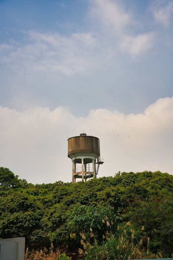 Vertical Shot of a Water Tower Near the Forest Stock Photo - Image of ...