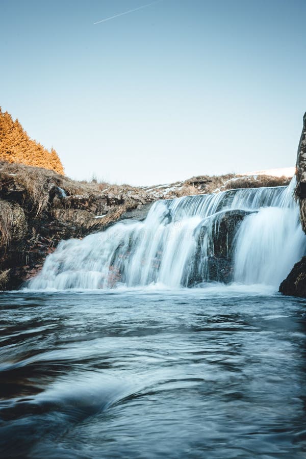 Vertical Shot of a Waterfall Cascading Over Rocks Stock Image - Image ...