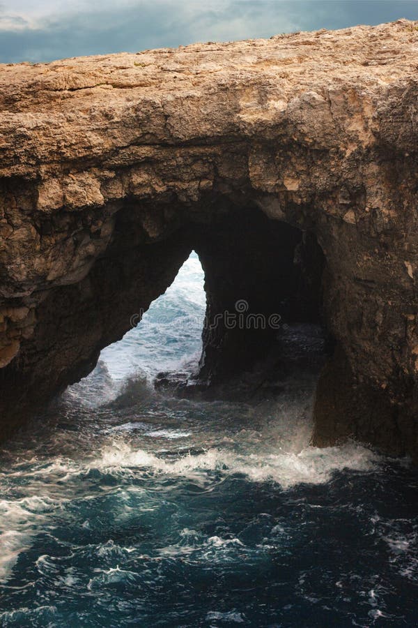 Vertical Shot of the Waters of the Ocean Under a Cliff Stock Photo ...